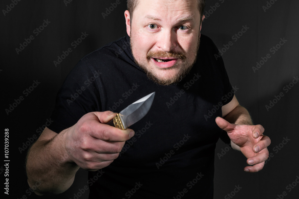 Portrait of a gangster with a knife Photos | Adobe Stock