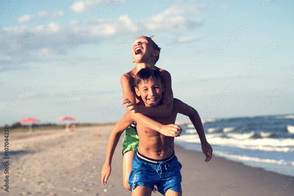 Happy kids playing on the beach on summer holidays. Stock Photo | Adobe ...