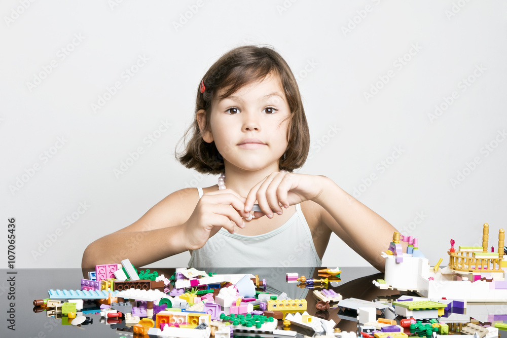 Little girl playing in lego blocks Stock Photo | Adobe Stock