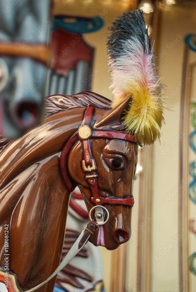 Bright carousel in a holiday park. Horses on a traditional fairground ...
