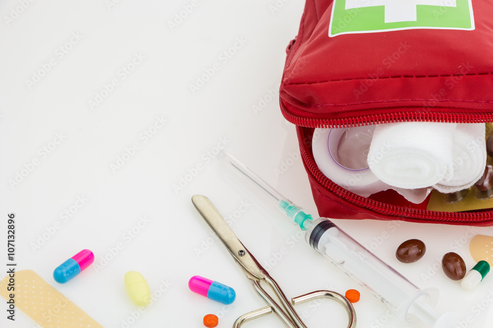 Opened first aid kit with medical equipment, isolated on white ...
