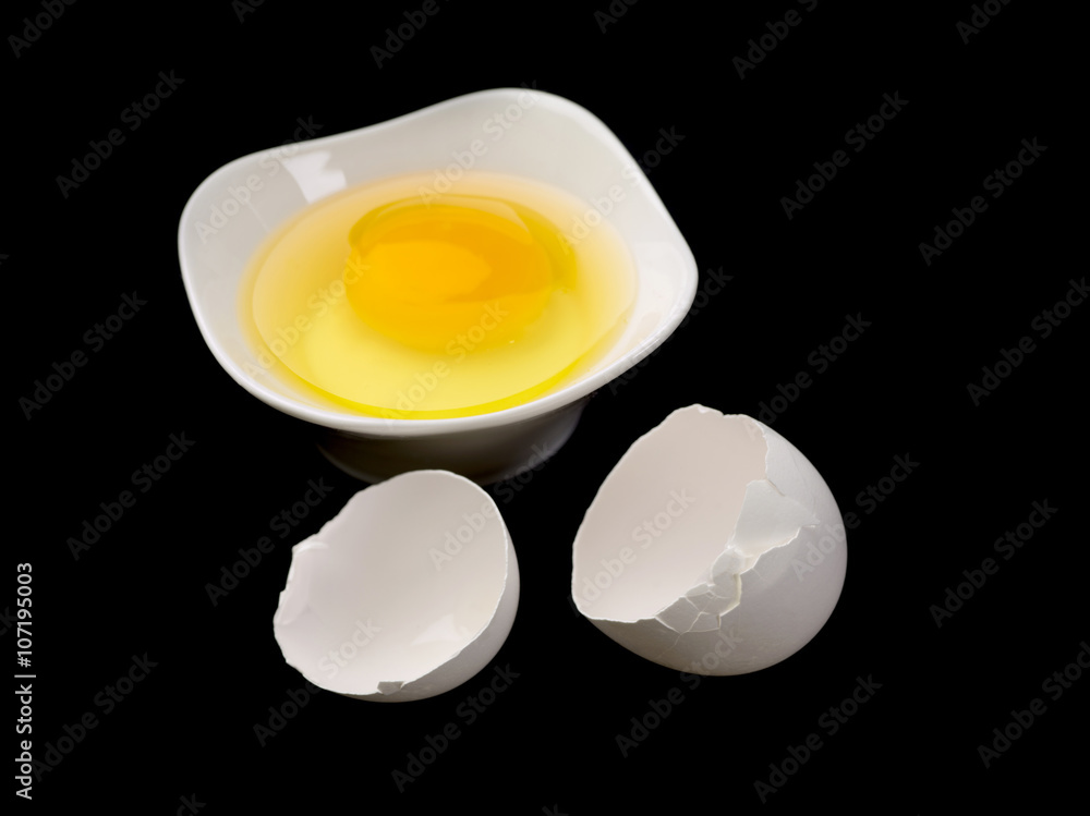egg yolk in white plate with egg shell Stock Photo | Adobe Stock
