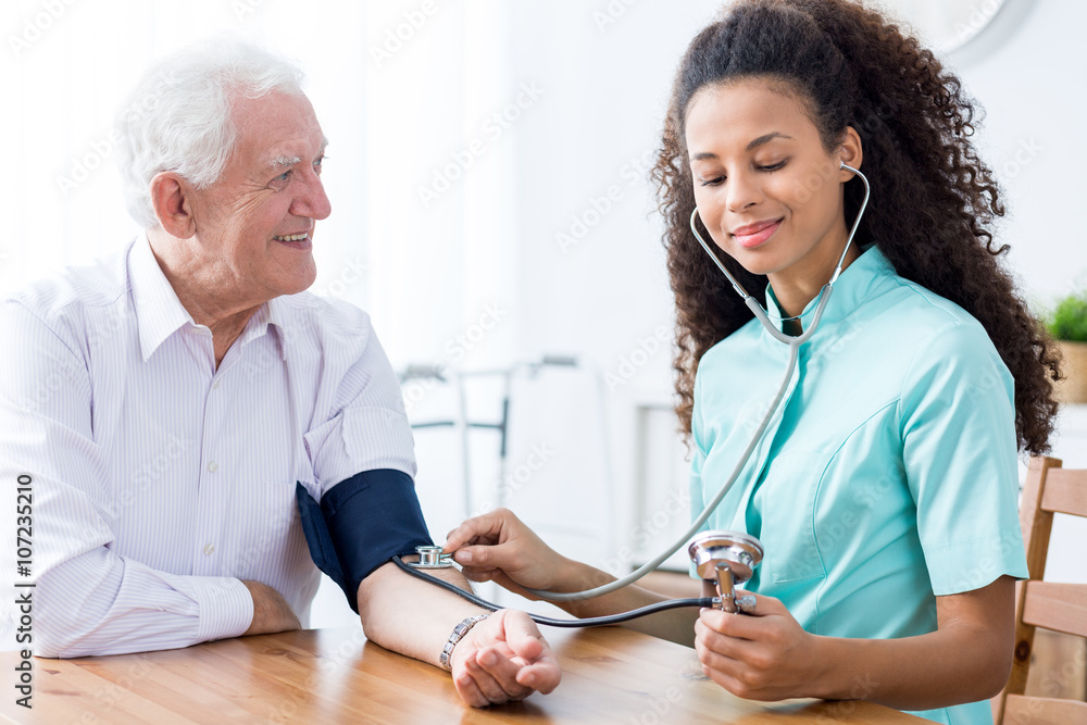 Professional nurse checking patient's blood pressure Stock-Foto | Adobe ...