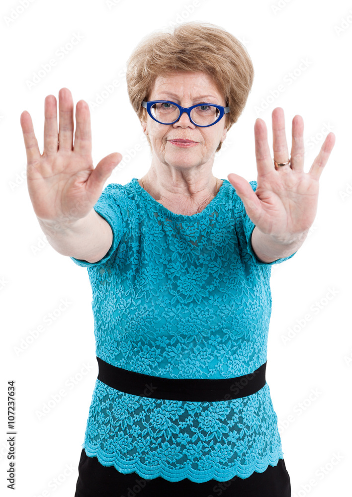 Elderly Caucasian wnoman stretching out two hands, gesturing stop sign ...