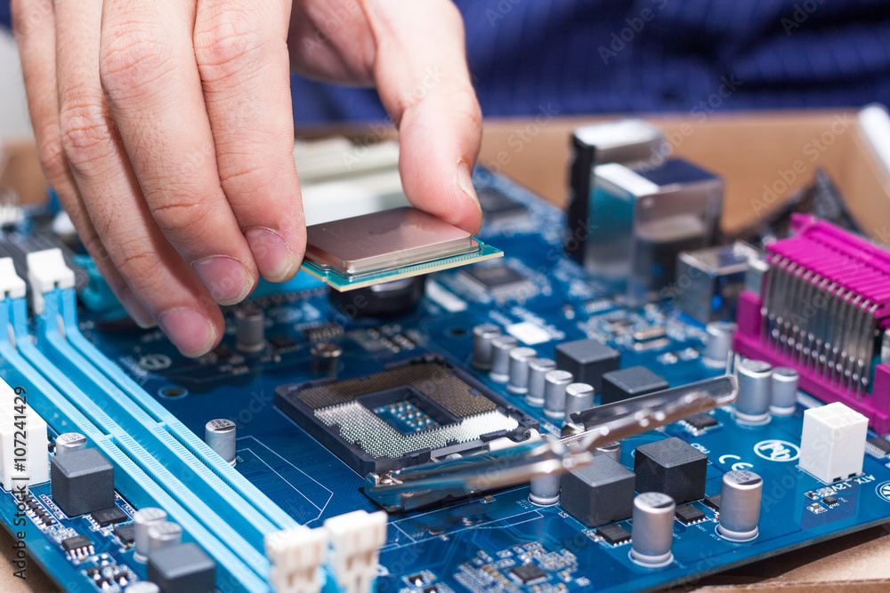 Assembling high performance personal computer, inserting CPU, processor into the motherboard ...