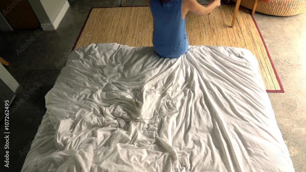 Happy woman in dress falling on bed, super slow motion 240fps Stock ...