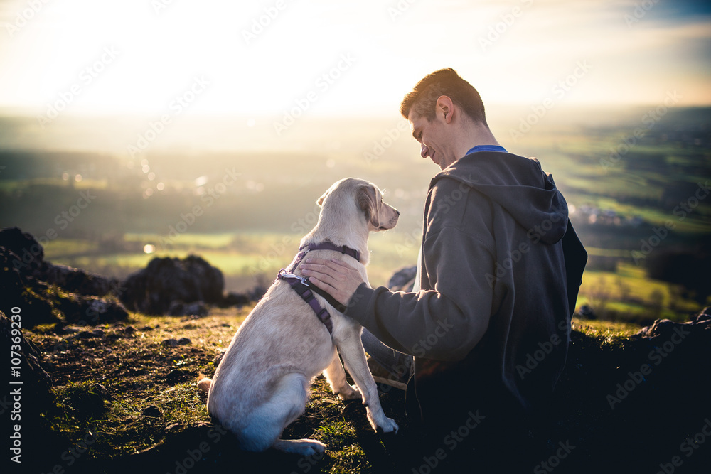 Dog and man in landscape Stock Photo | Adobe Stock