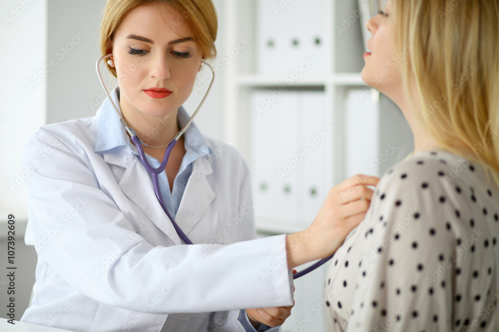Doctor examines a patient with a stethoscope Stock Photo | Adobe Stock