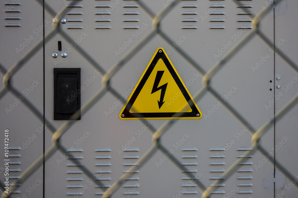 electrical hazard sign placed on a electric power substation behind a ...