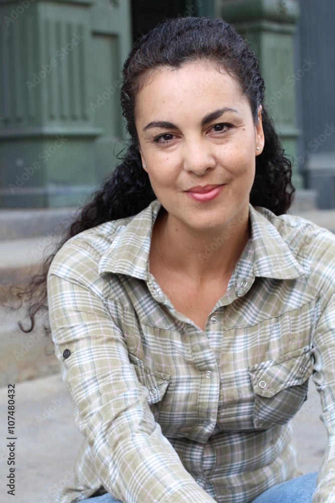 Vertical image of beautiful hispanic woman in a casual plaid shirt in ...