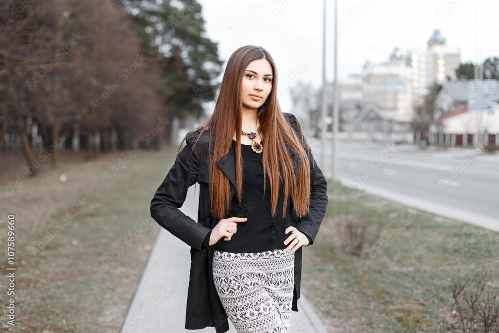Beautiful young girl with long hair in a stylish black coat Stock Photo ...