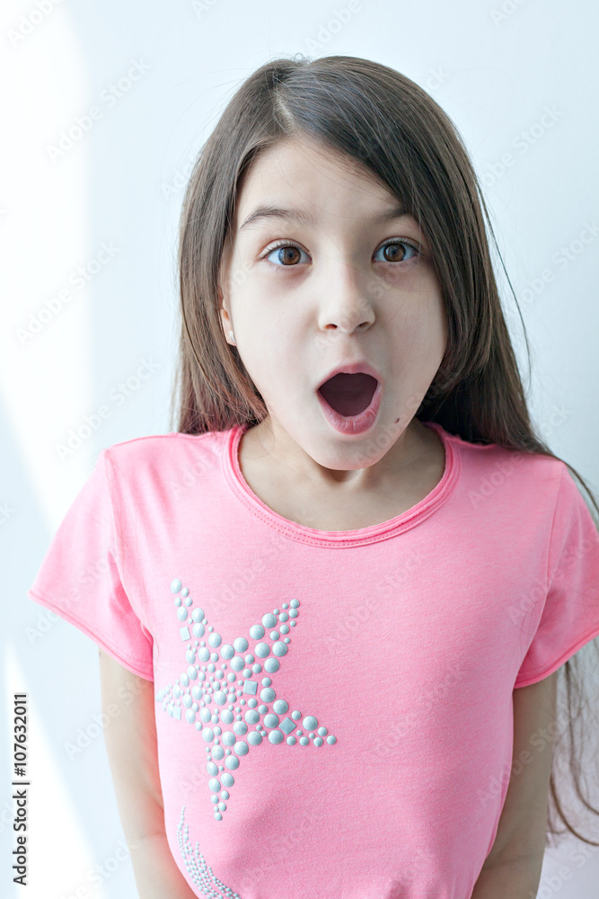 Foto Stock Little girl making a funny face. | Adobe Stock Foto Stock Little girl making a funny face. | Adobe Stock