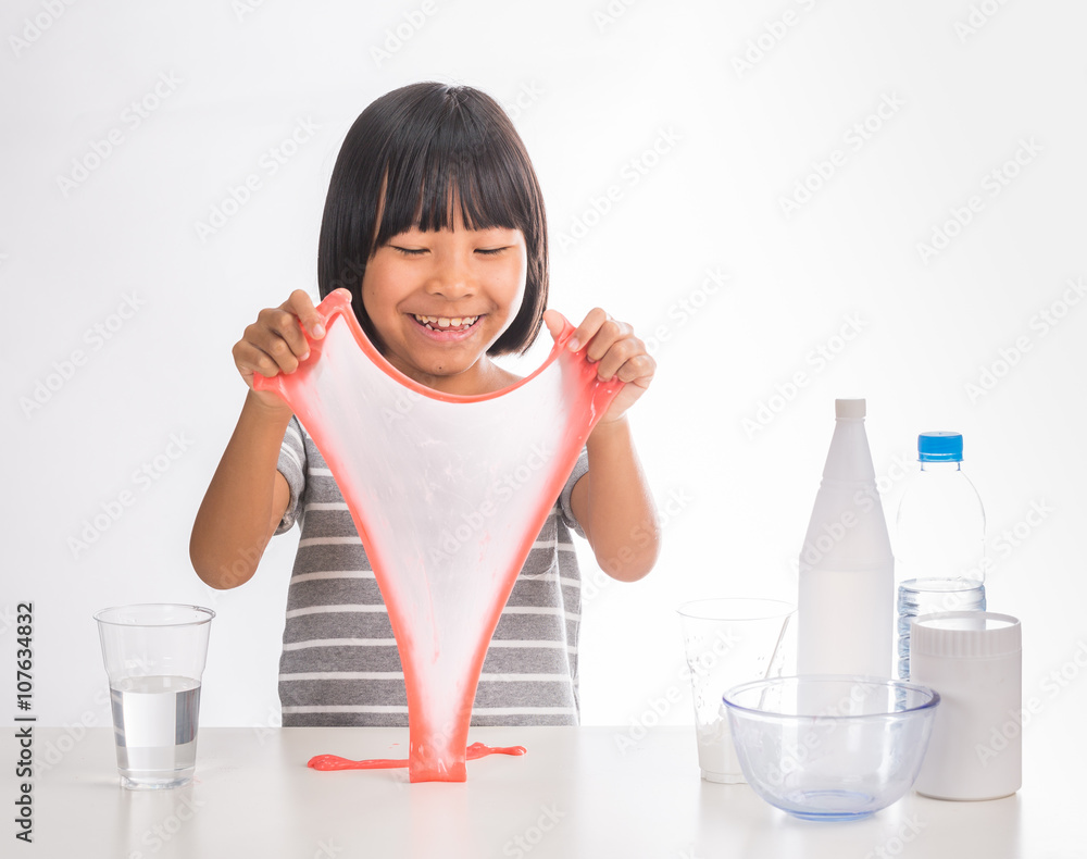 cute little asian girl making science experiment of slime on isolate ...