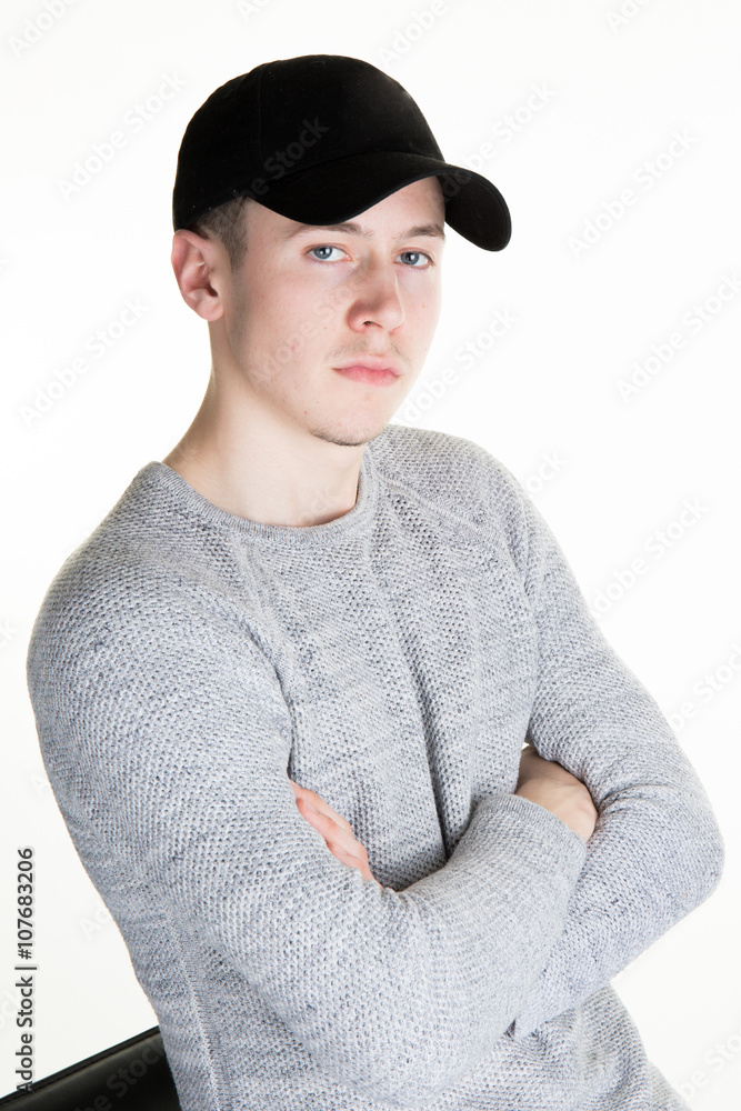 Smiling handsome young man wearing a peaked cap Stock Photo | Adobe Stock