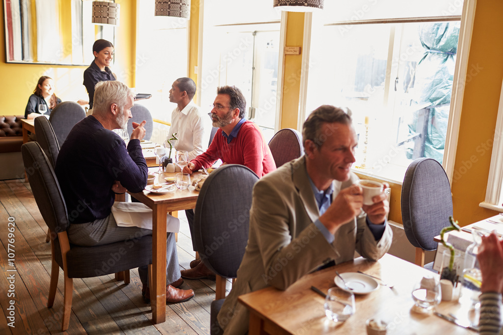 Overview of customers and a waitress in restaurant interior Stock Photo ...