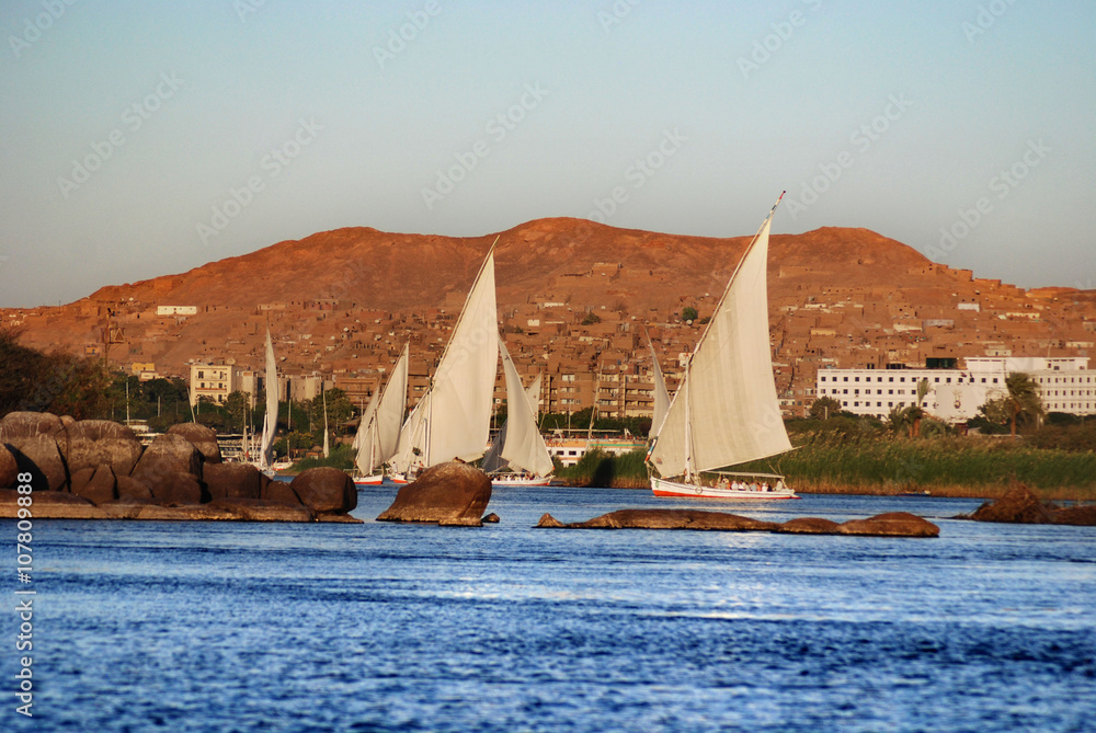 Felucca sails on the Nile river near Aswan, Egypt. .The feluccas seen ...