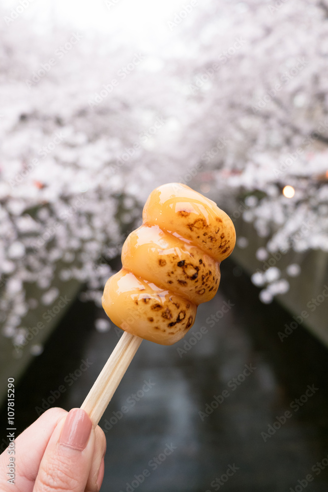japanese sweet recipe dango grilled with sakura background Stock Photo ...
