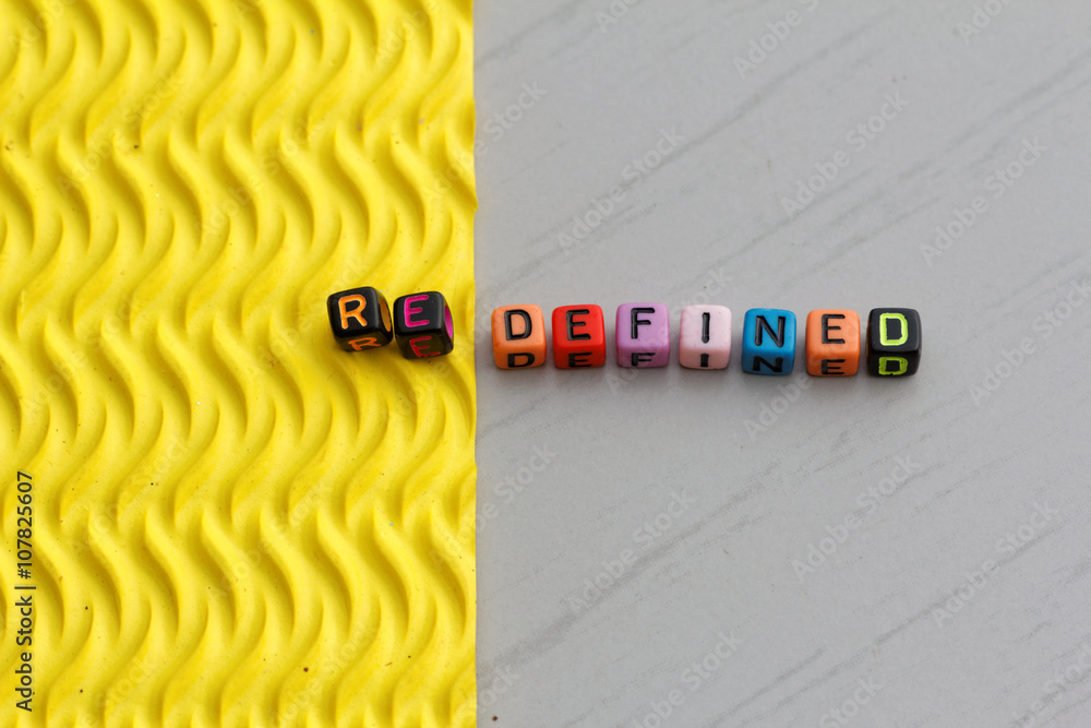 Plastic alphabet block arranged to form word REDEFINED. Two different ...