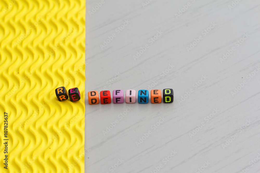 Plastic alphabet block arranged to form word REDEFINED. Two different ...