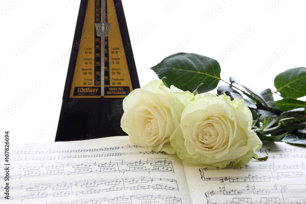 music notes, metronome and white roses Stock Photo | Adobe Stock