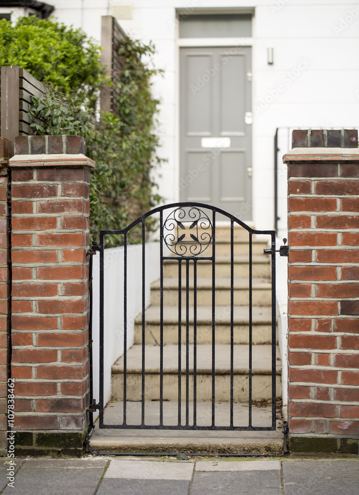 Welcome Home. An ornate wrought iron gate is a happy symbol of coming home. By opening the gate ...