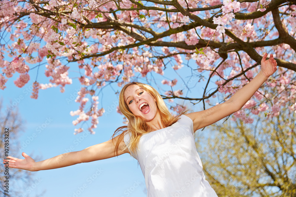 Girl under pink cherry blossom tree Stock Photo | Adobe Stock