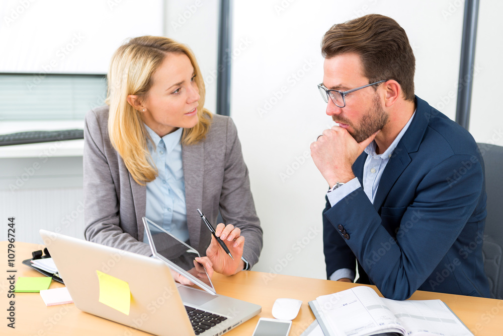 Businessman and his assistant working together at the office Stock ...