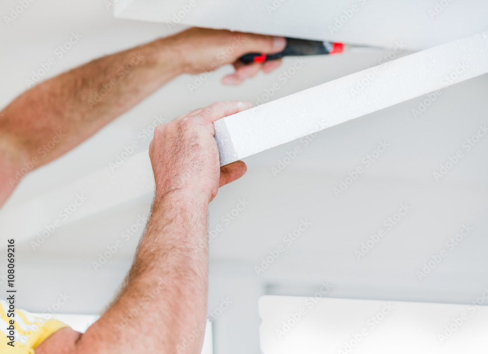 Constructor insulating the ceiling from the interior with polyethylene ...