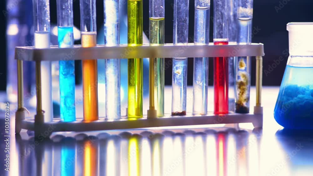 Test tubes with colored reagents and flask with blue reagent in the ...