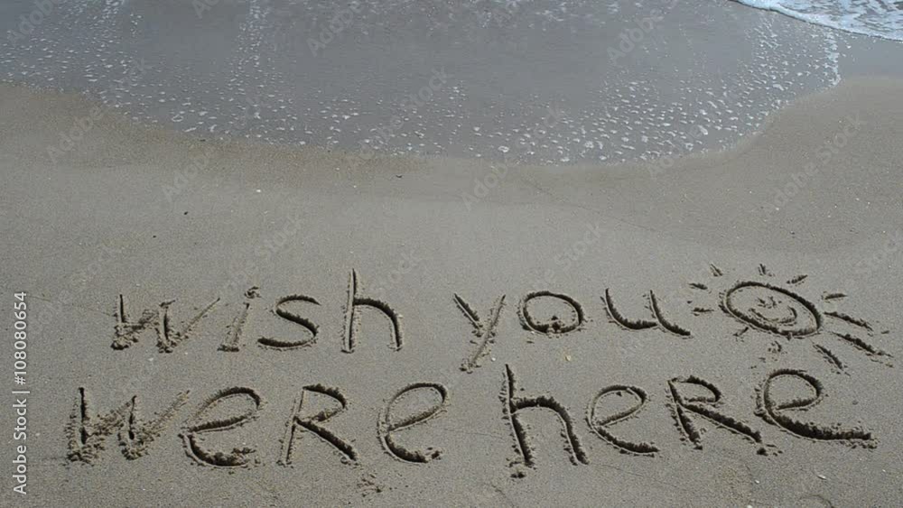 Conceptual wish you were here text handwritten in sand on a beach Stock ...