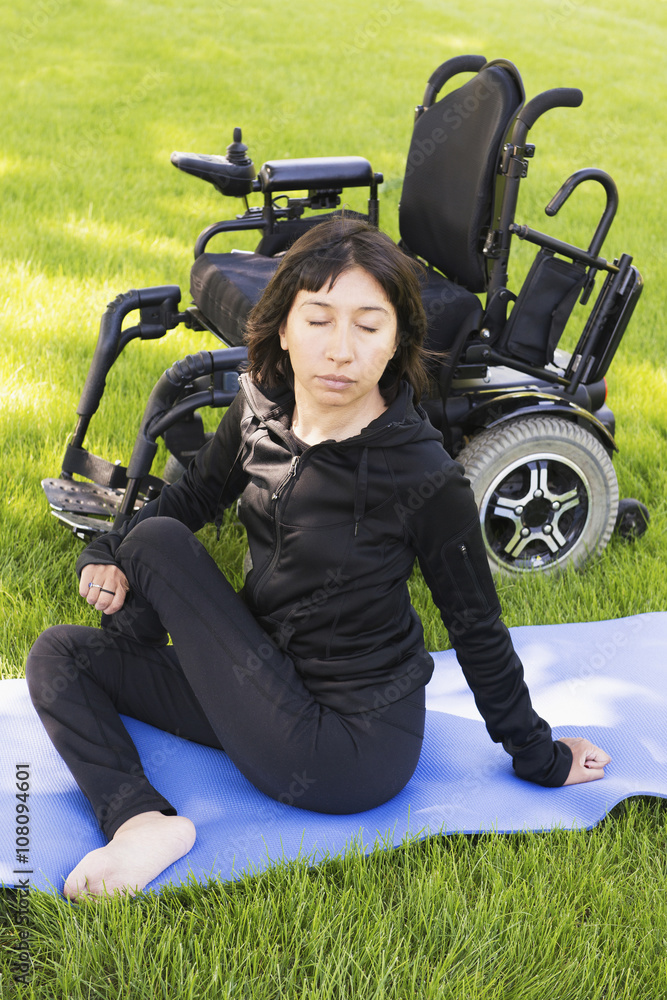 Disabled woman stretching legs in park Stock Photo | Adobe Stock