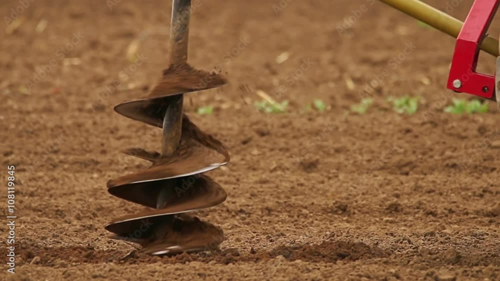 Tractors digging holes for fruit trees in the farm, rural landscape in ...