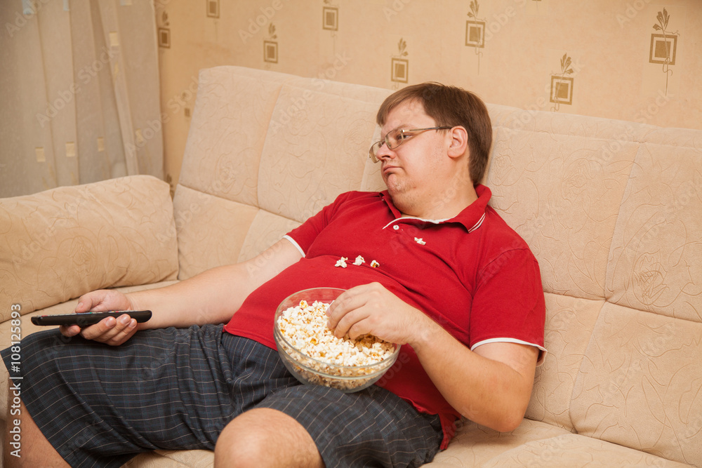 fat man eating popcorn Stock Photo | Adobe Stock