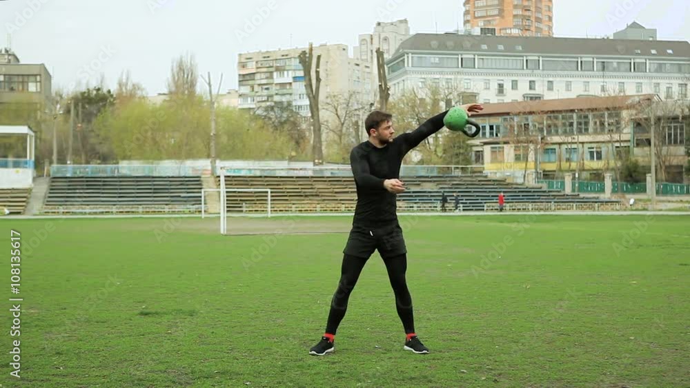 Exercise Young Athlete Wearing a Black Tracksuit With Weights 32 on the ...