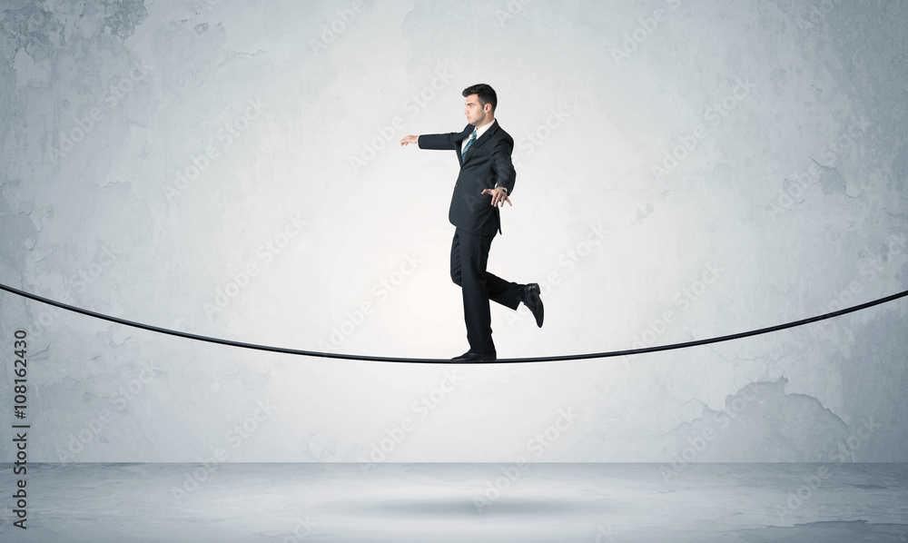 Sales guy balancing on tight rope Stock Photo | Adobe Stock