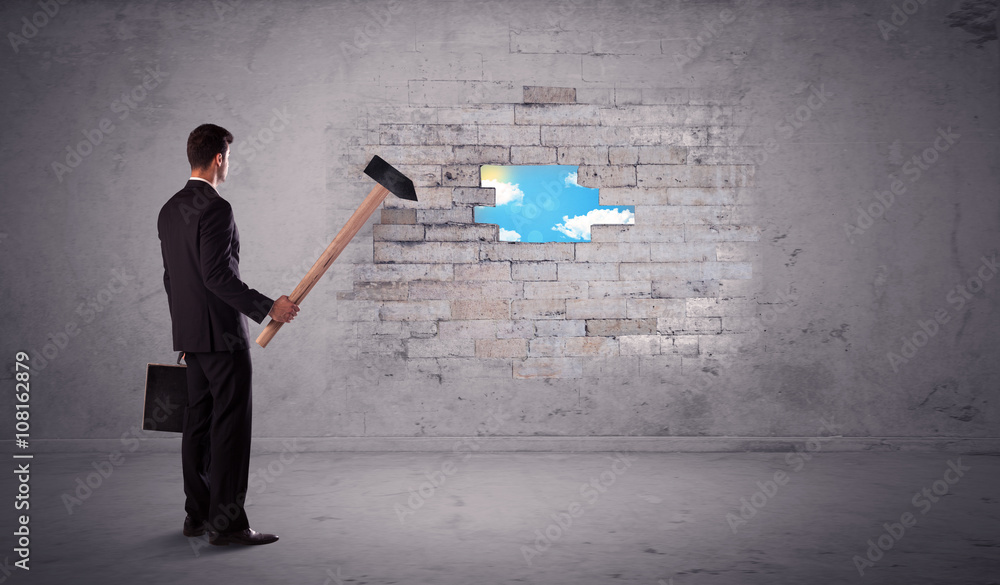 Business man hitting brick wall with hammer Stock Photo | Adobe Stock