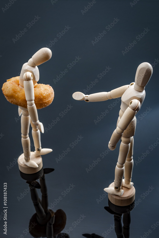 Two human shaped figurines one portrayed as overweight because of a ...