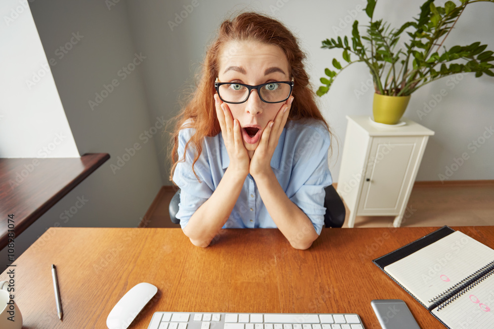 Top portrait of young surprised woman holding her face with shock. Cute ...