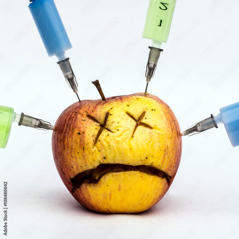 Photo & Art Print Sad/scared apple with syringes, GMO concept ...