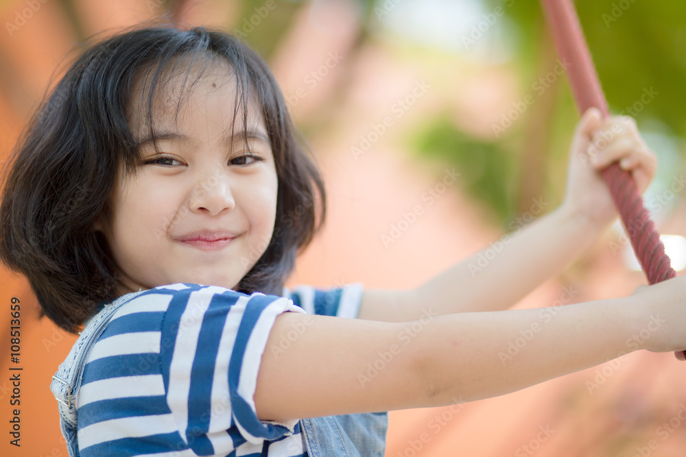 Cute children. Asian girl climbing in a rope playground structure at ...