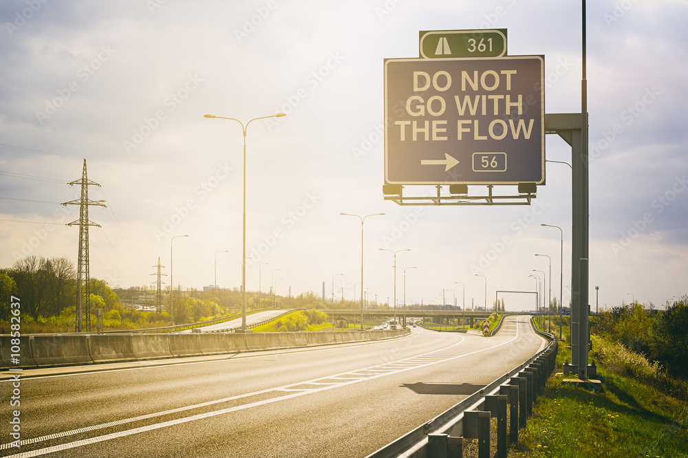 Traffic sign with text Do Not Go With The Flow. Appeal to noncoformism ...