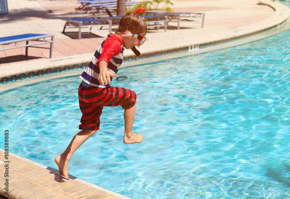 Little boy jumping into swimming pool Stock Photo | Adobe Stock