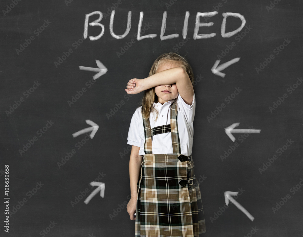 junior schoolgirl crying victim of bullying suffering stress and fear ...