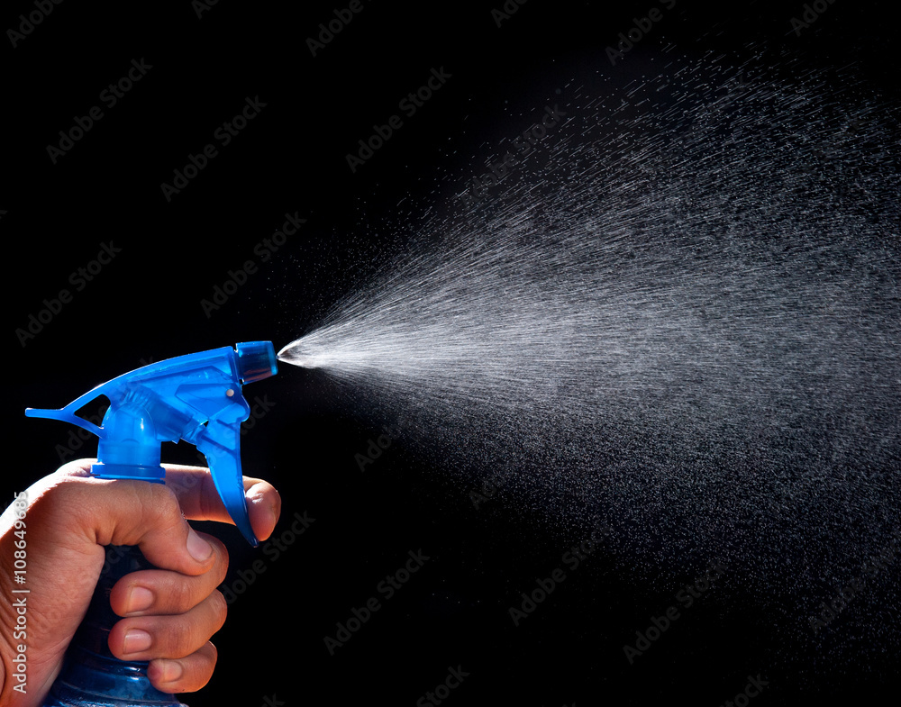 Liquid is sprayed from an atomizer Stock Photo | Adobe Stock