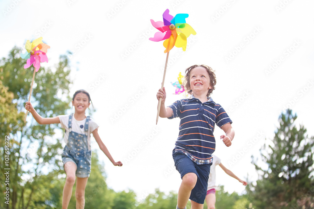 Kids with pinwheels Stock Photo | Adobe Stock