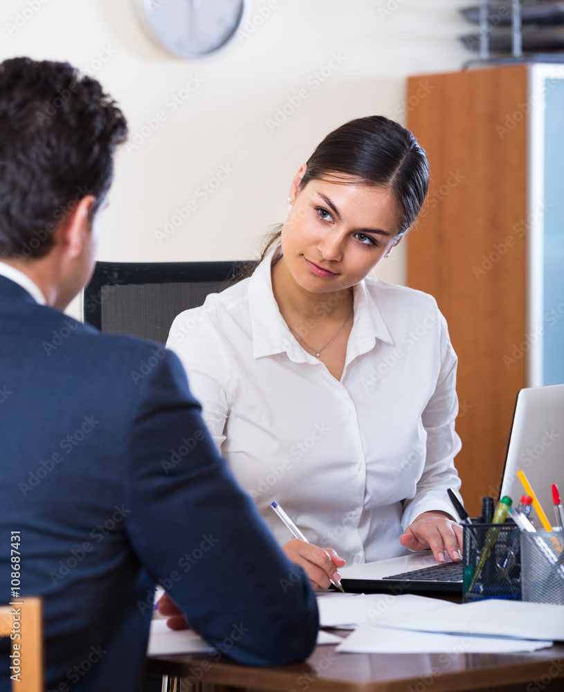 agent listening to customer and smiling in agency Stock Photo | Adobe Stock