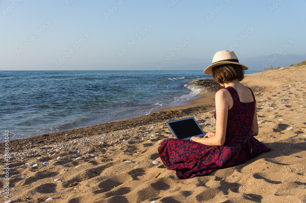 Woman working at the beach фотография Stock | Adobe Stock