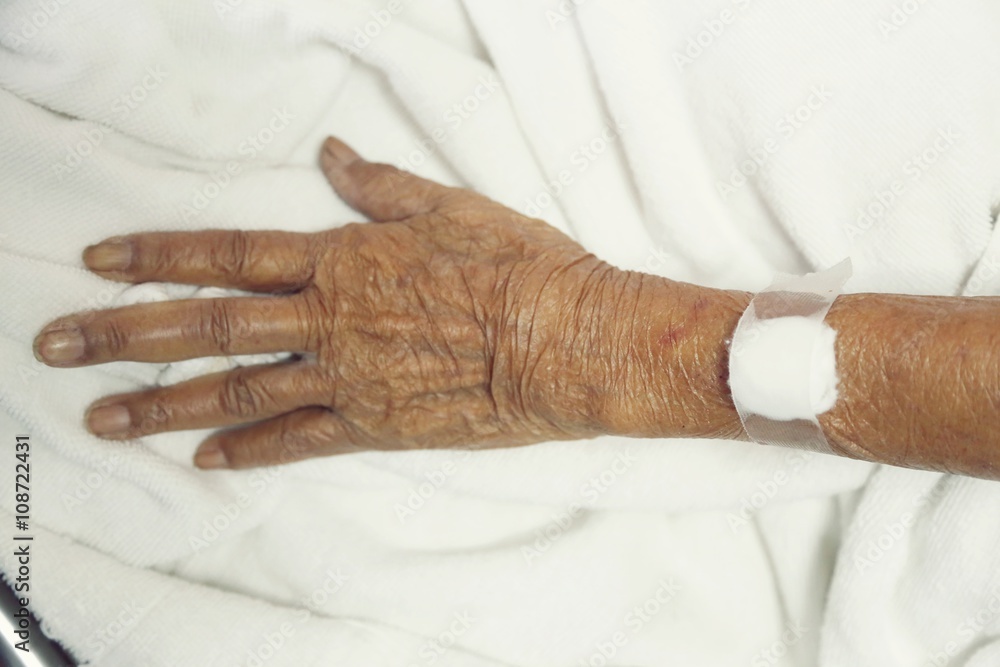 old woman's hand is on a drip receiving a saline solution. Stock Photo ...