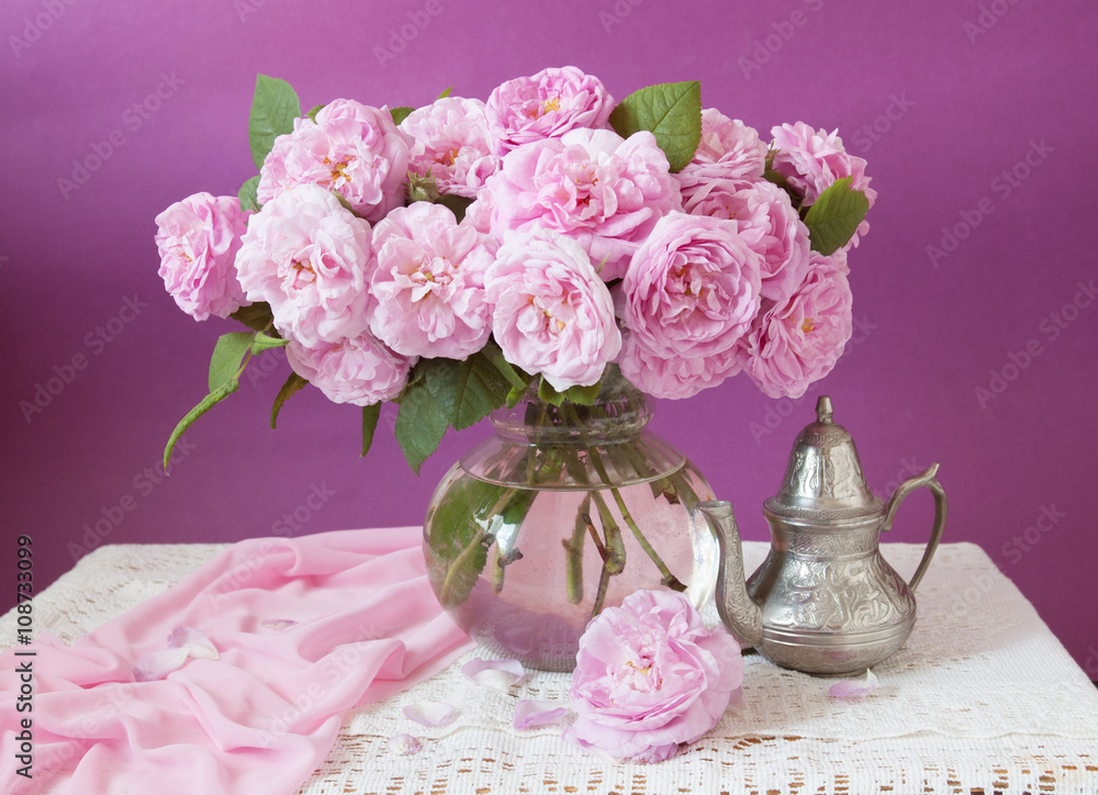 Still life with huge bunch of pink roses, books and globe on painting ...