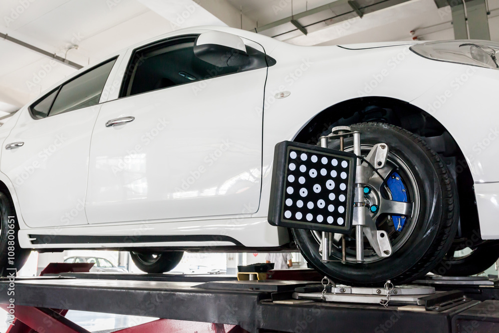 Suspension adjustment and Automobile wheel alignment work being ...